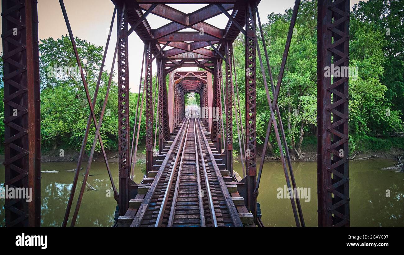 Aerial of train tracks over river with metal frame Stock Photo - Alamy