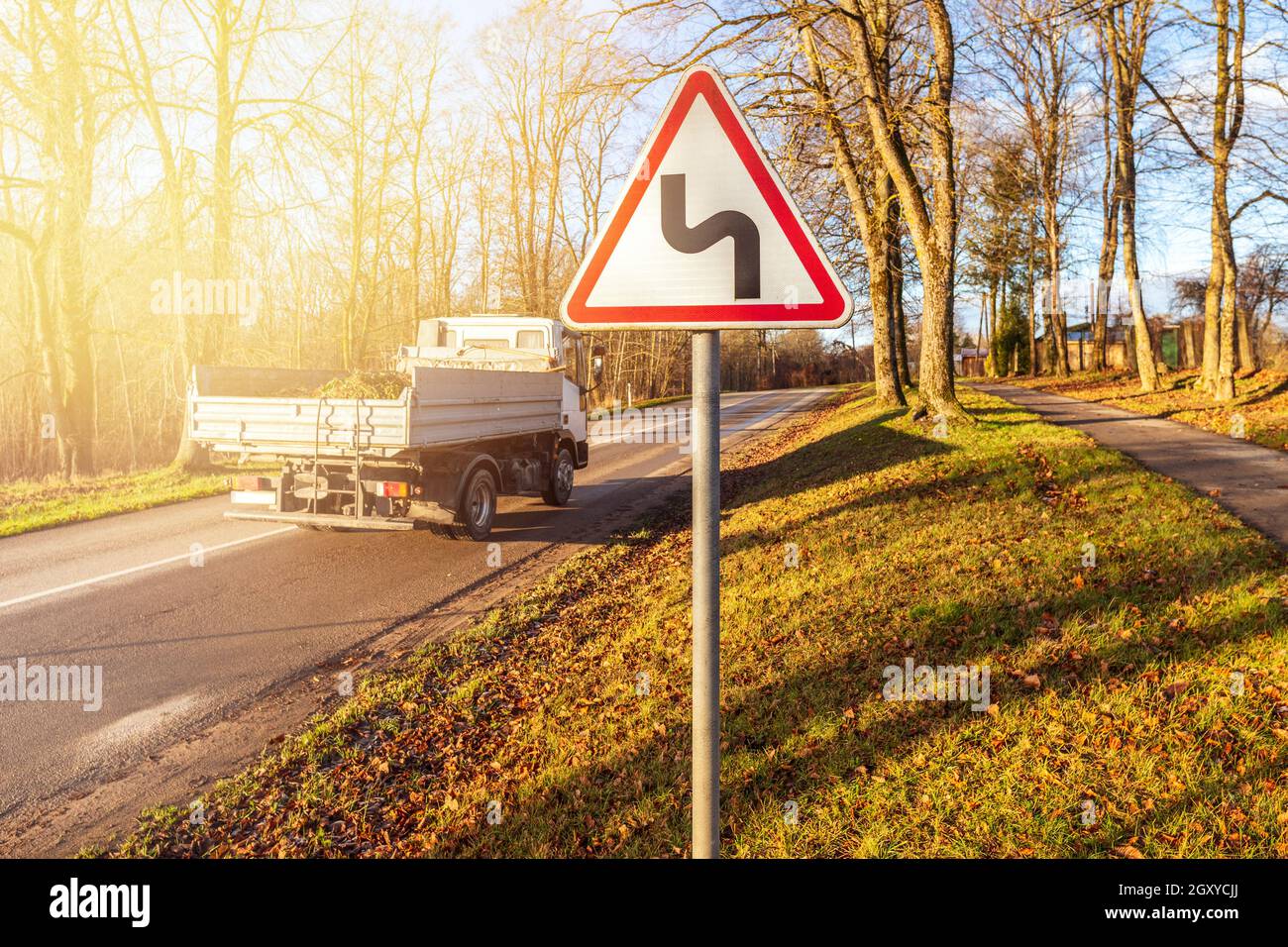Curved road traffic sign on dangerous rural road Stock Photo - Alamy