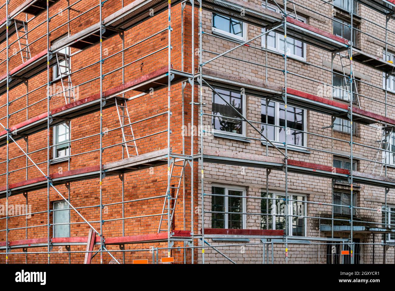 Tall building under construction with scaffolds. Construction site ...