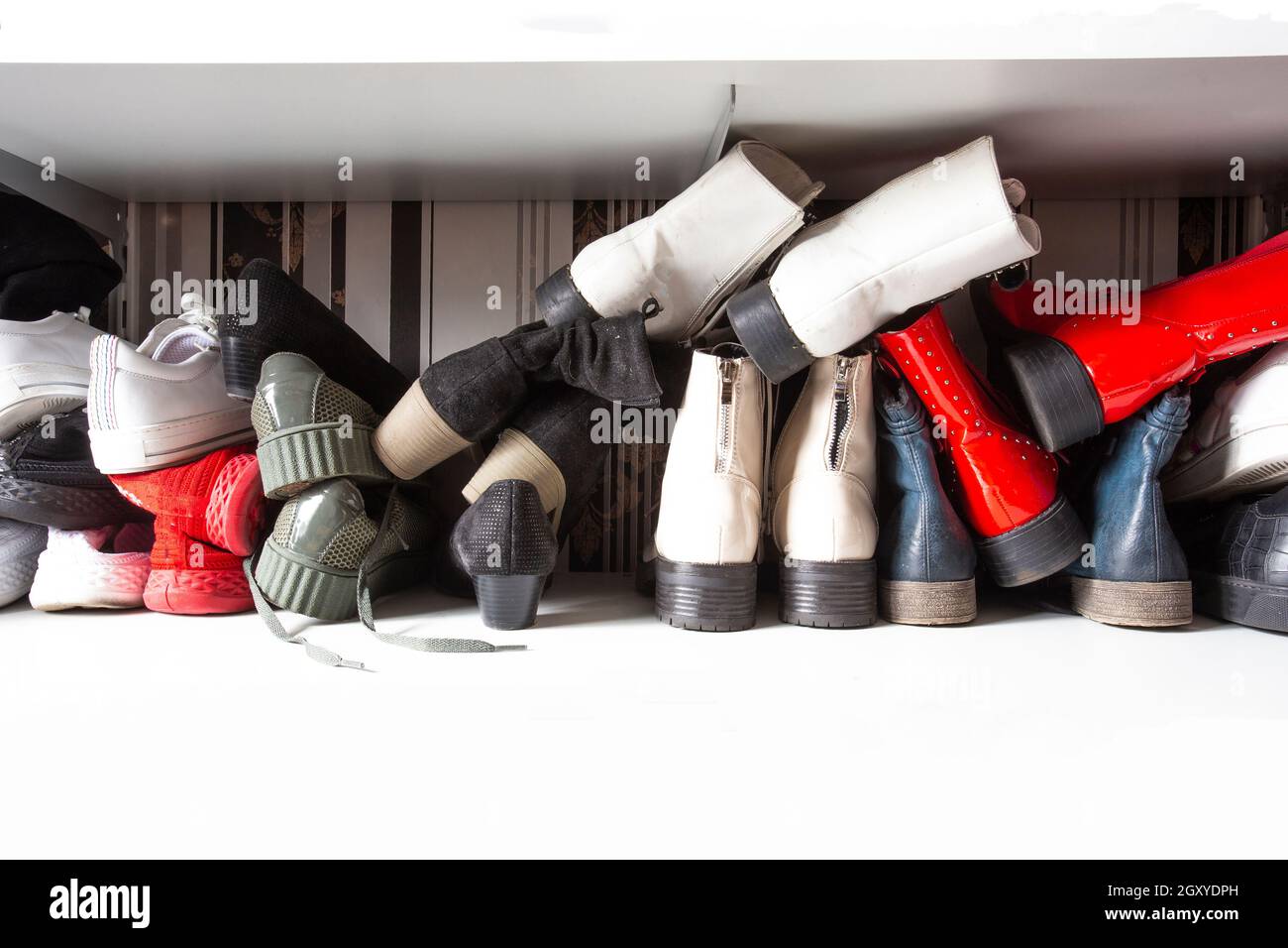 Collection of old different shoes in shoe rack for storage, messy and ...