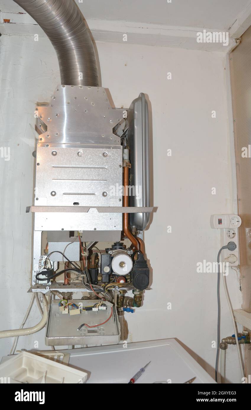 Repair of a gas boiler, setting up and servicing gas boiler Stock Photo ...