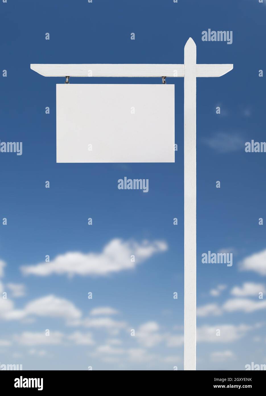 Blank Real Estate Sign Over A Blue Sky with Clouds Stock Photo - Alamy