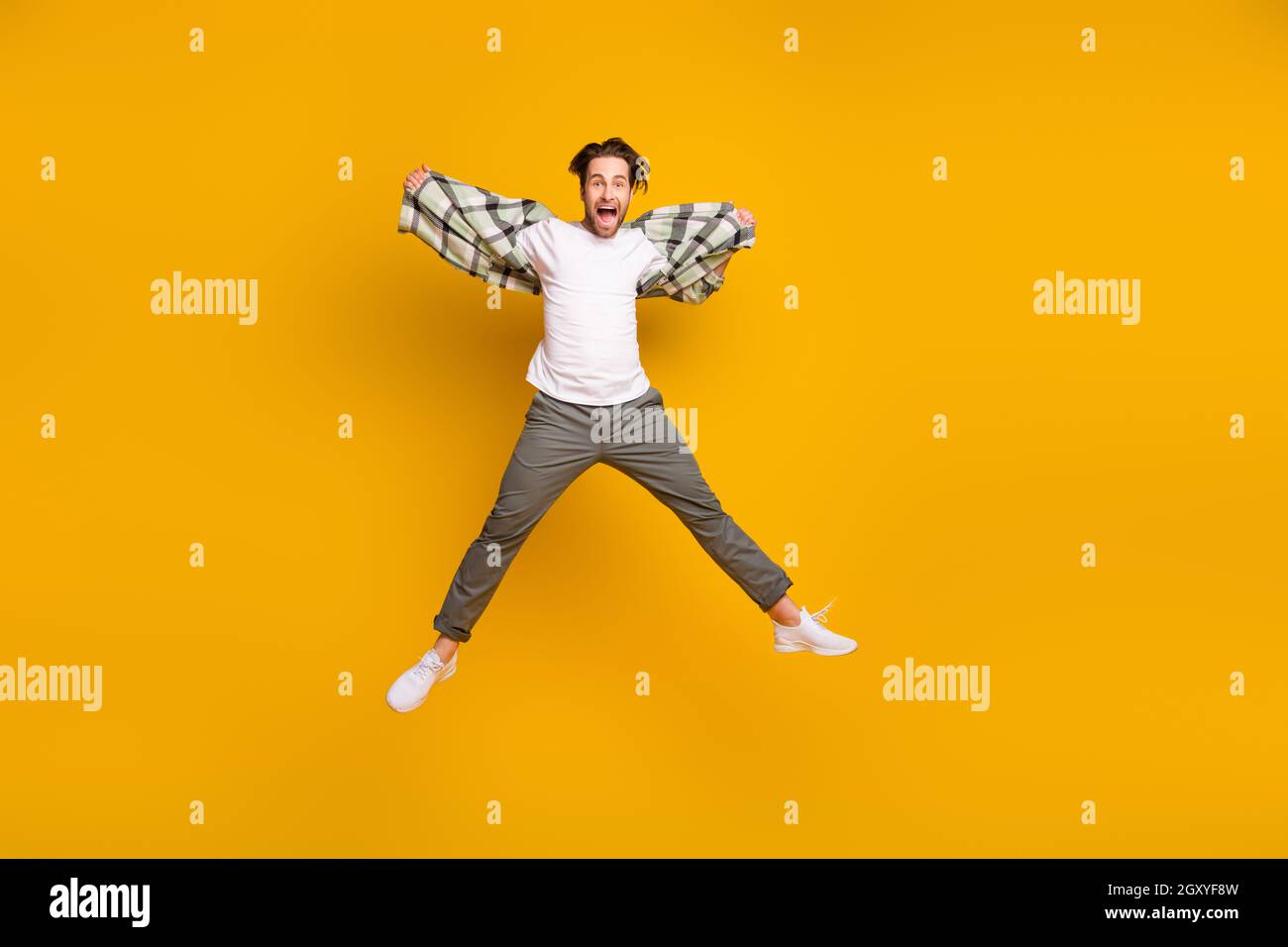Full length photo of young excited man amazed shocked yell jump up ...