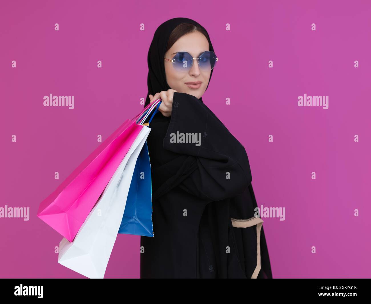 Happy muslim girl posing with shopping bags. Arabic woman wearing ...