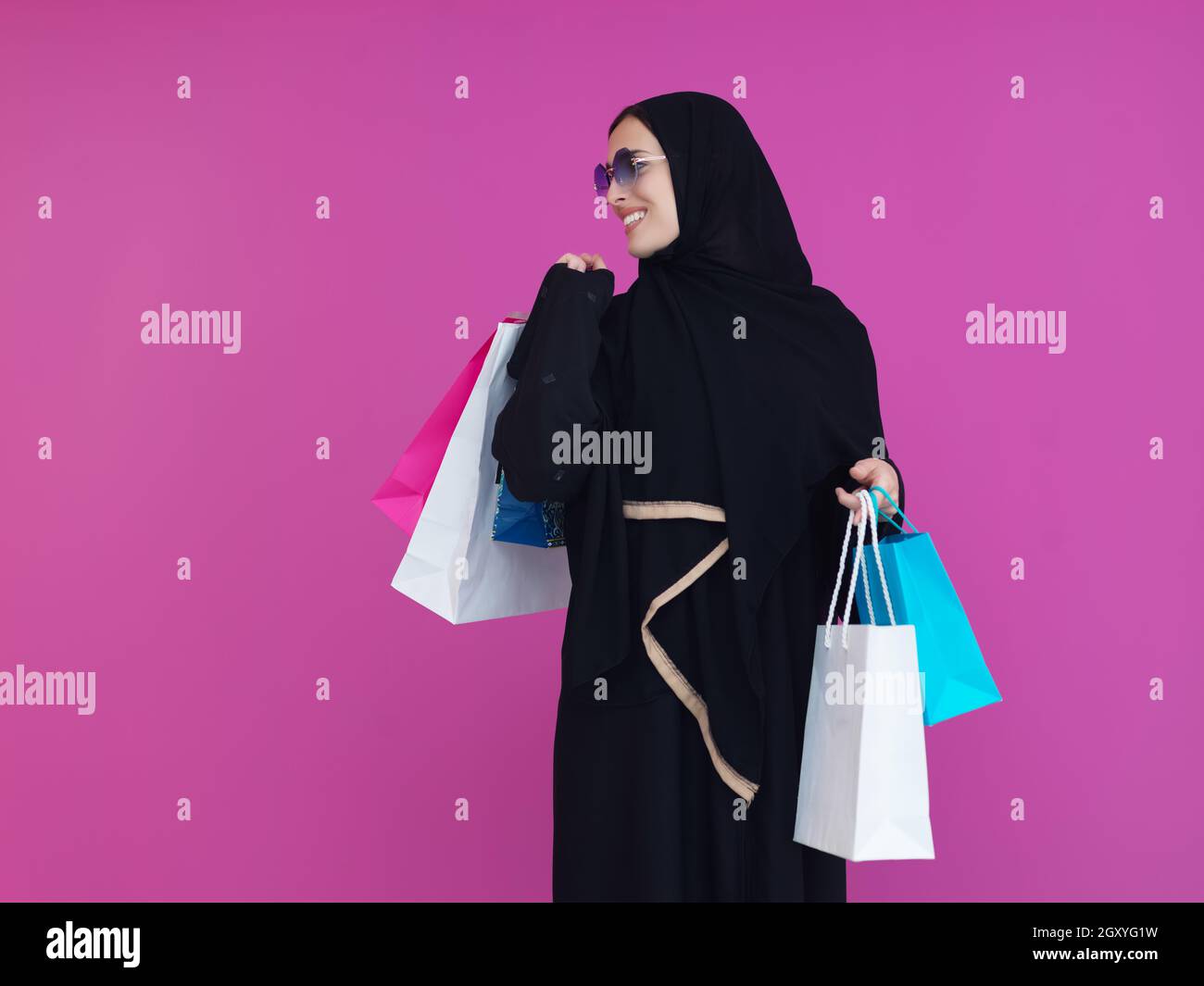 Happy muslim girl posing with shopping bags. Arabic woman wearing ...