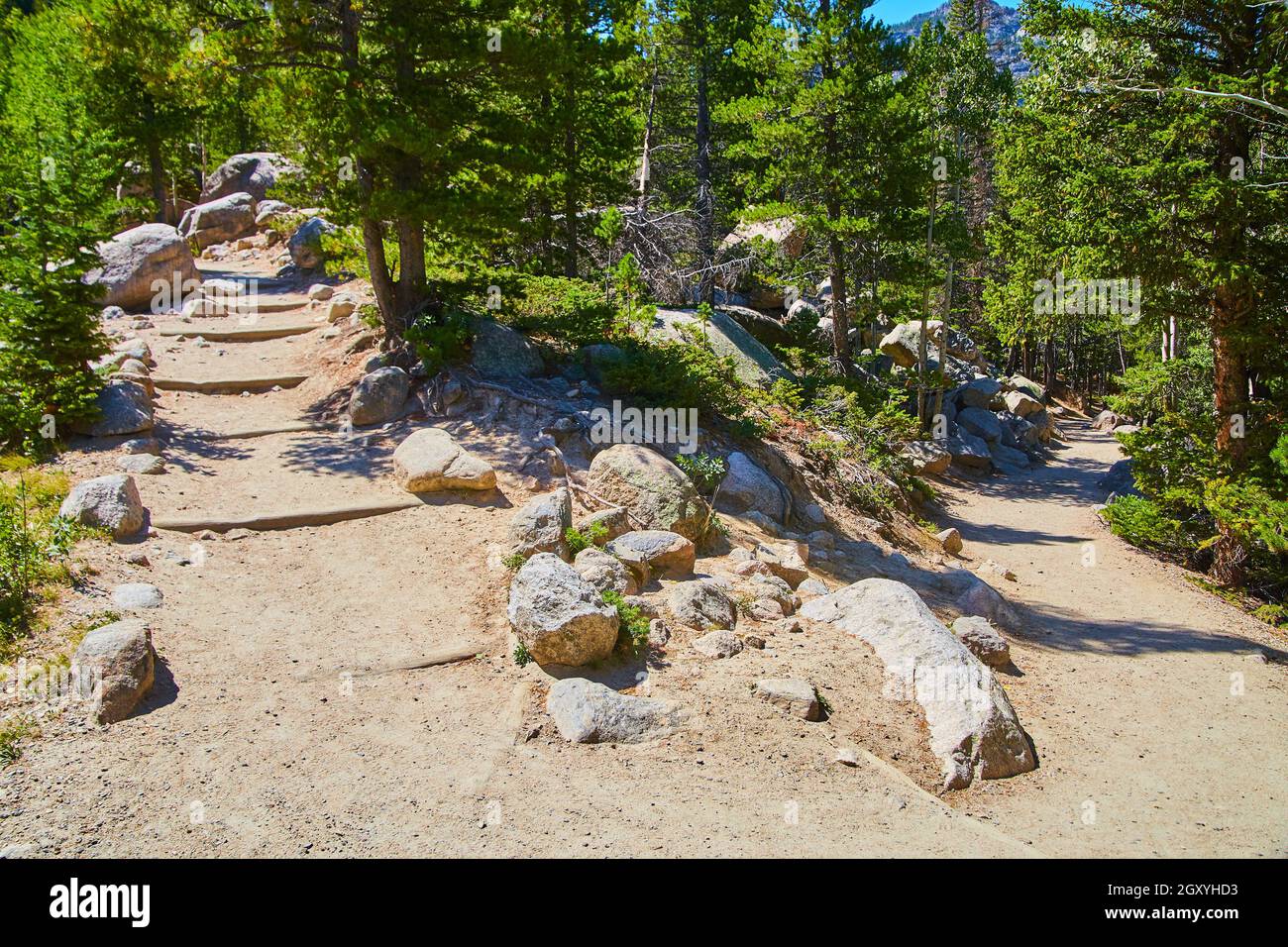 Walking path up mountain with steps and stone guides Stock Photo - Alamy