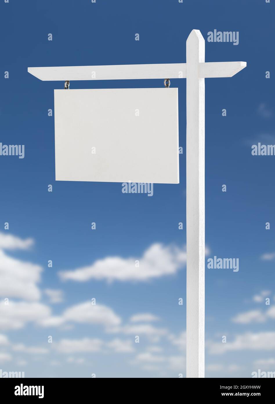 Blank Real Estate Sign Over A Blue Sky with Clouds Stock Photo - Alamy