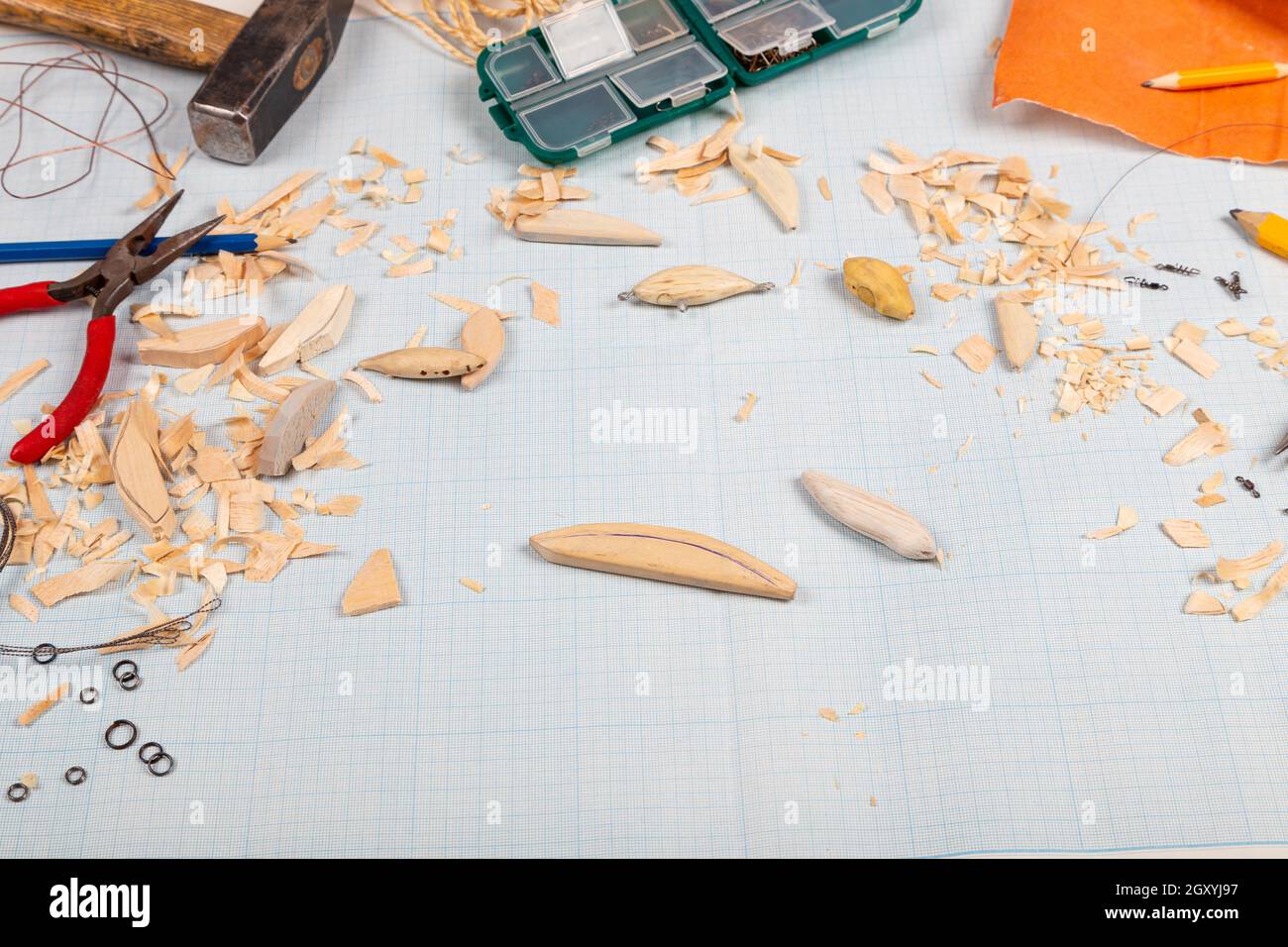 Handmade wooden fishing tacles graph paper background with tools and ...