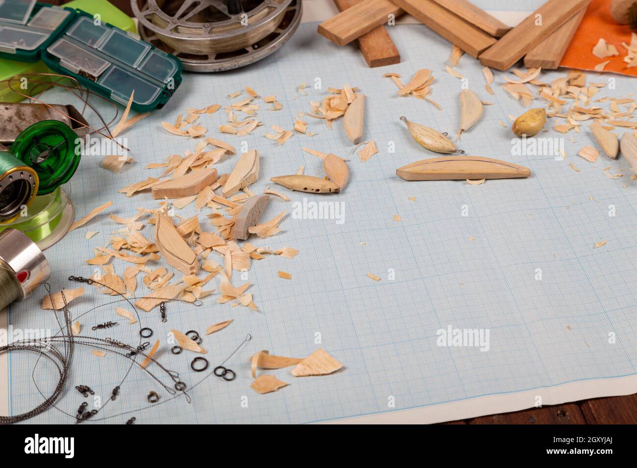 Handmade wooden fishing tacles graph paper background with tools and ...