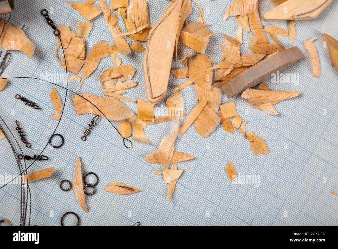 Handmade wooden fishing tacles graph paper background with tools and ...