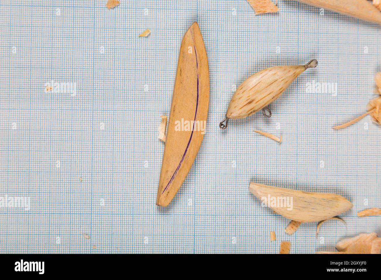Handmade wooden fishing tacles graph paper background with tools and ...