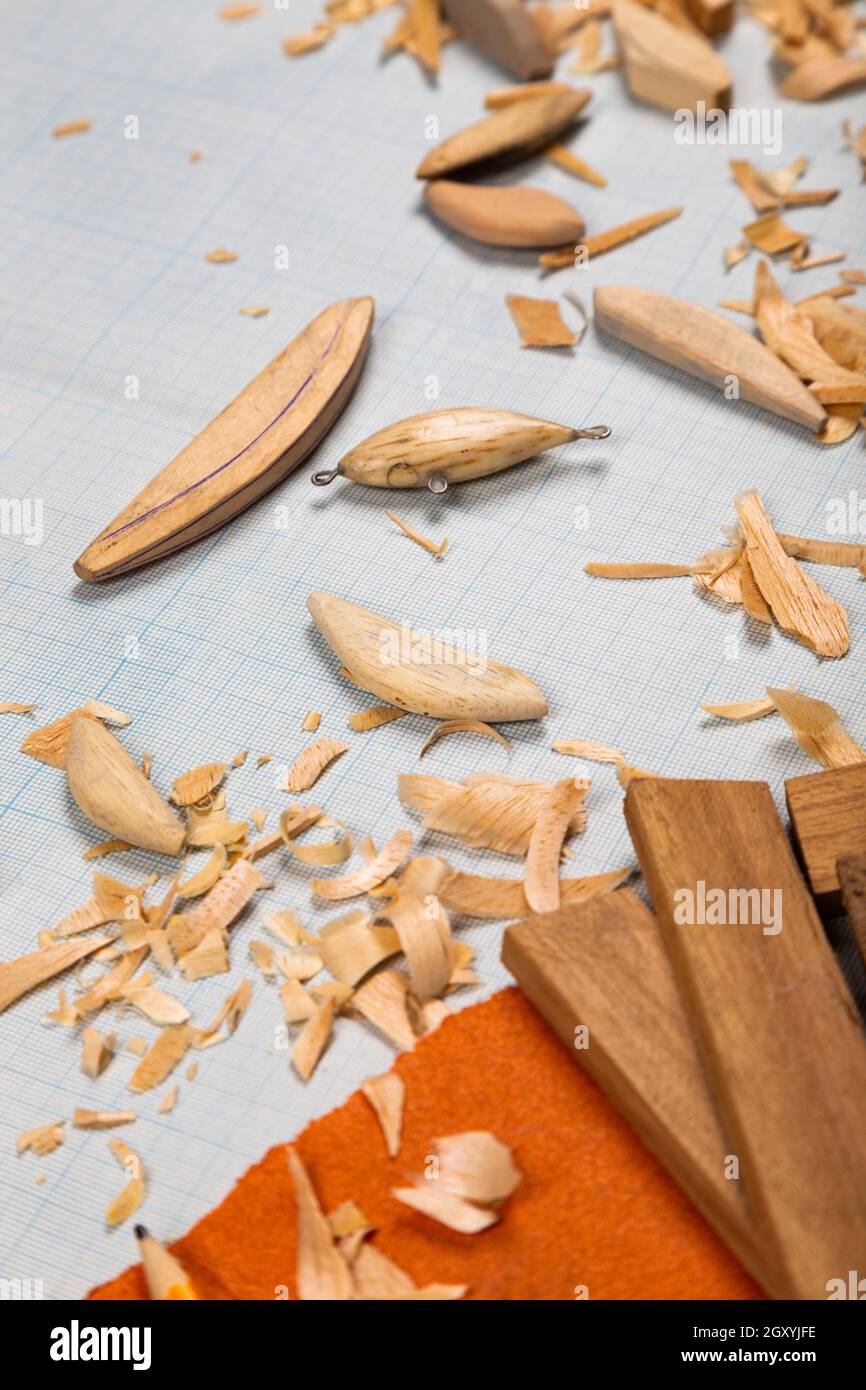 Handmade wooden fishing tacles graph paper background with tools and ...