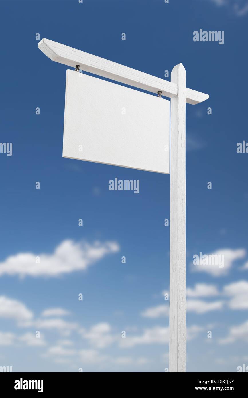 Blank Real Estate Sign Over A Blue Sky with Clouds Stock Photo - Alamy