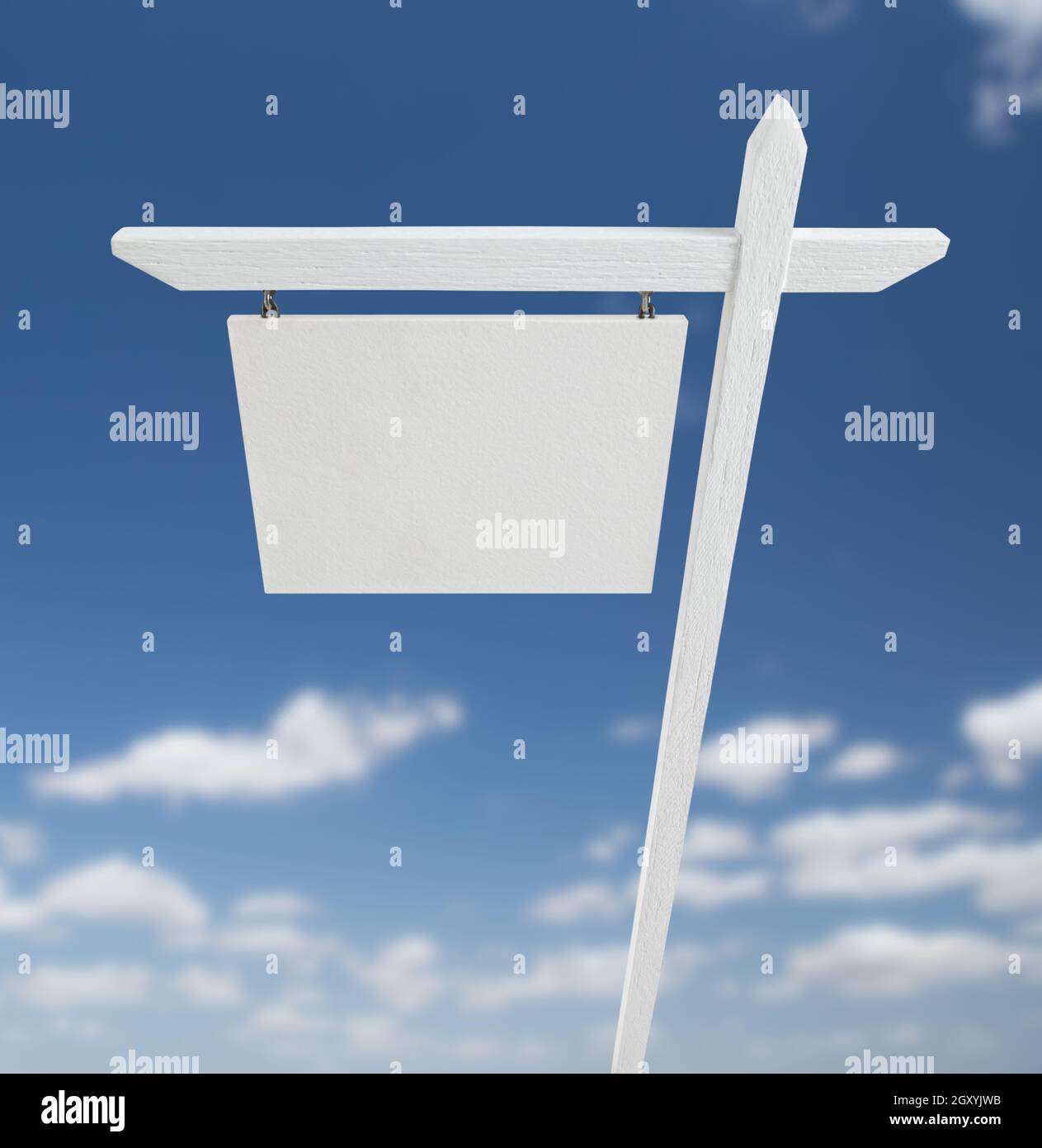 Blank Real Estate Sign Over A Blue Sky with Clouds Stock Photo - Alamy
