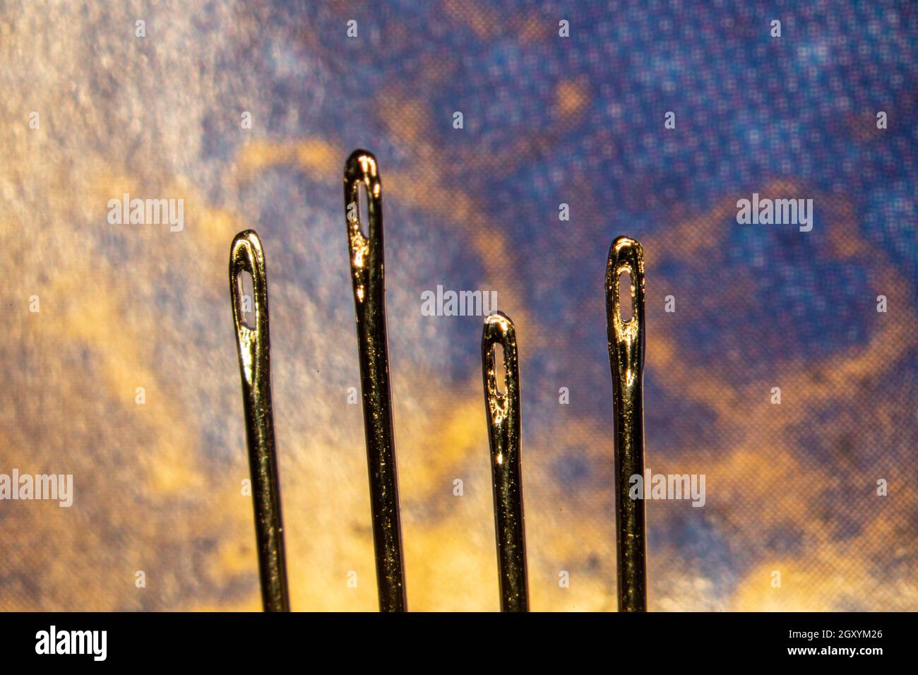Needle threaded with red thread hi-res stock photography and images - Alamy