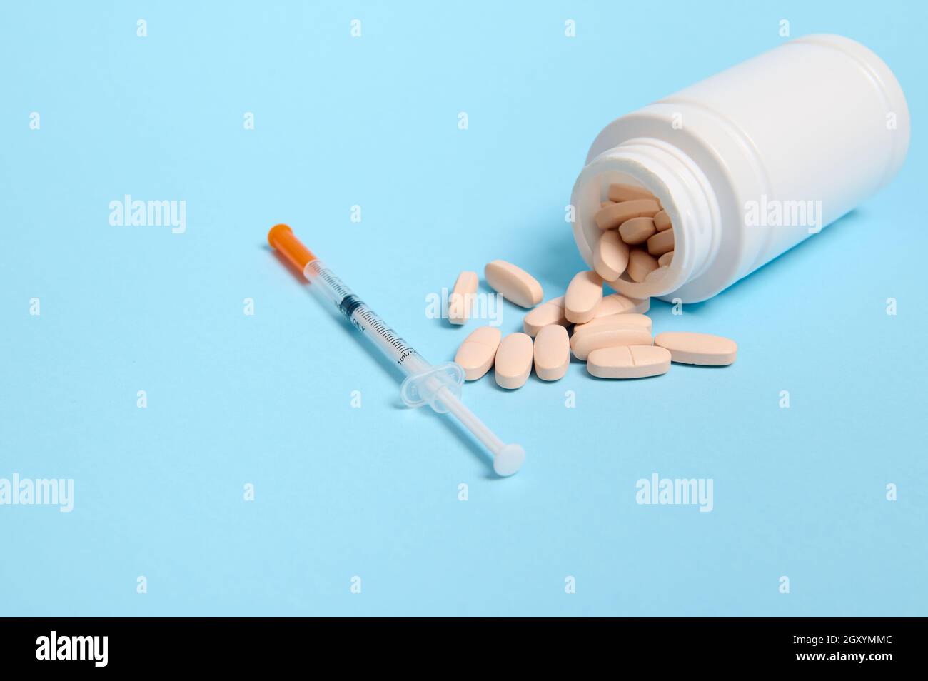 Composition of insulin syringe and pharmaceutical pills scattered from ...
