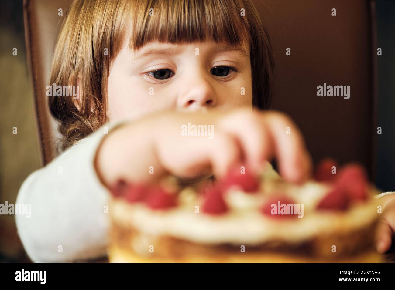 Cute Happy Baby Girl Eating Cake With Raspberries. Adorable little girl ...