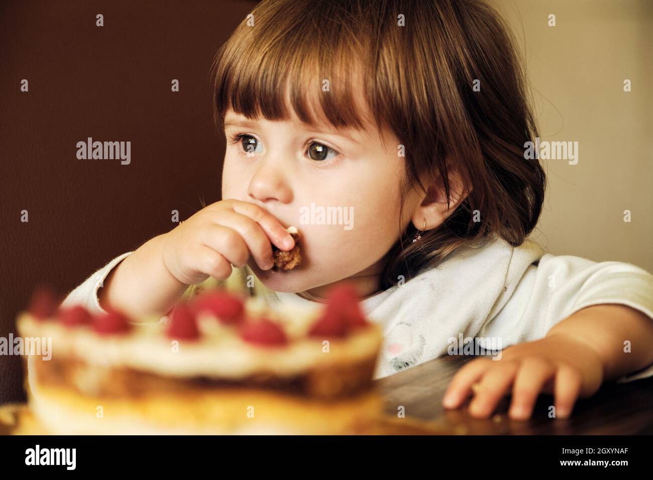 Cute Happy Baby Girl Eating Cake With Raspberries. Adorable little girl ...