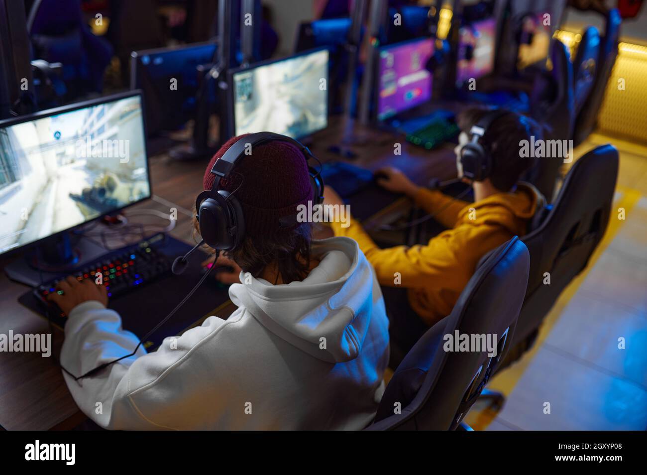Two young gamers play in game club. Virtual entertainment, e-sport ...
