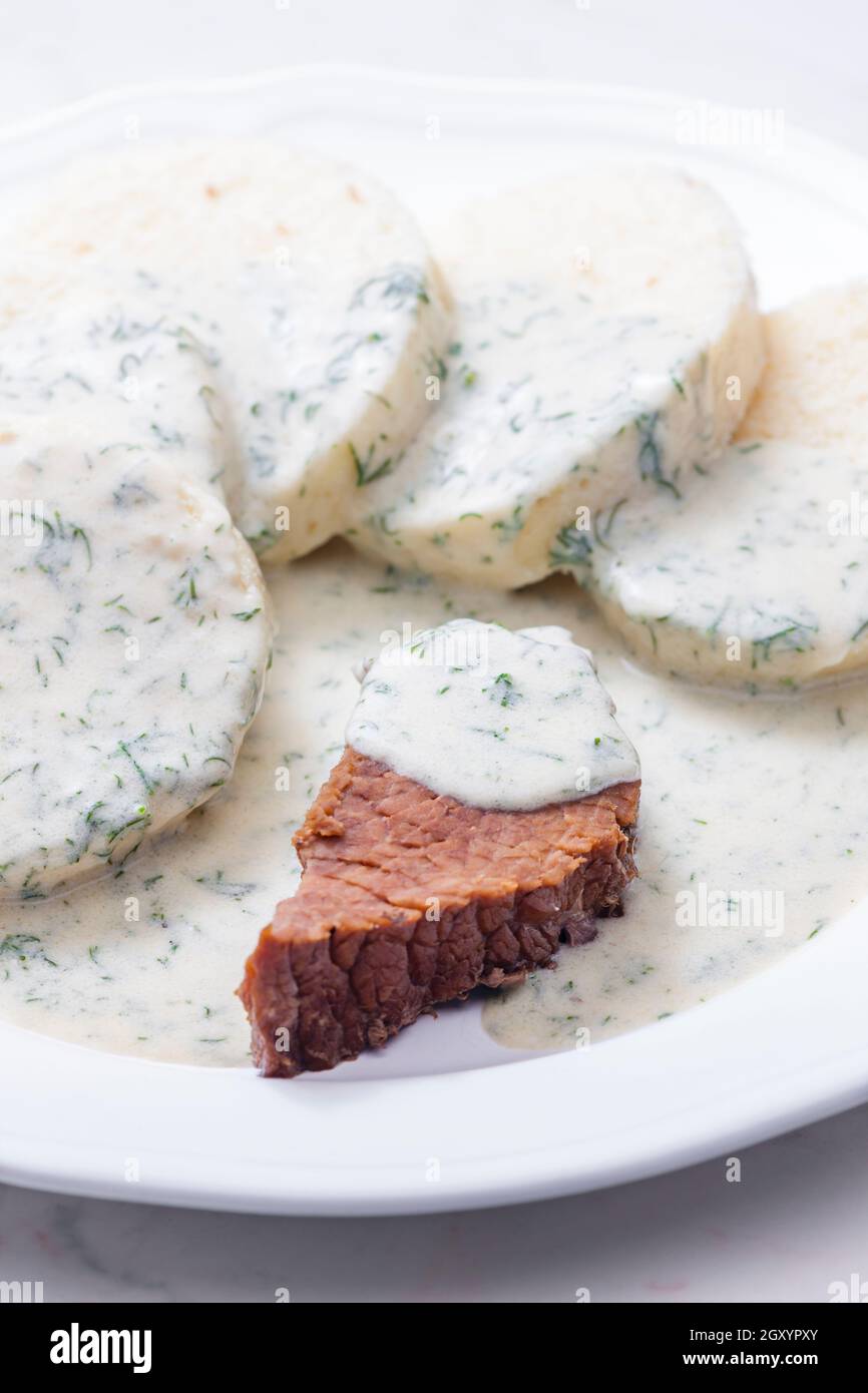 beef meat with dill sauce and dumplings Stock Photo - Alamy