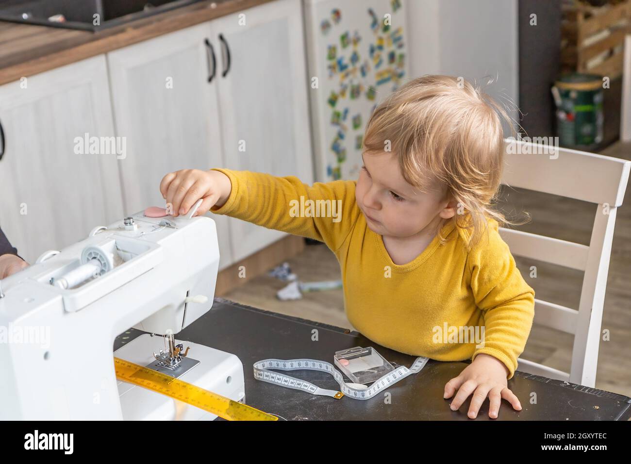 Little boy is helping with sewing at home. Horizontally Stock Photo - Alamy