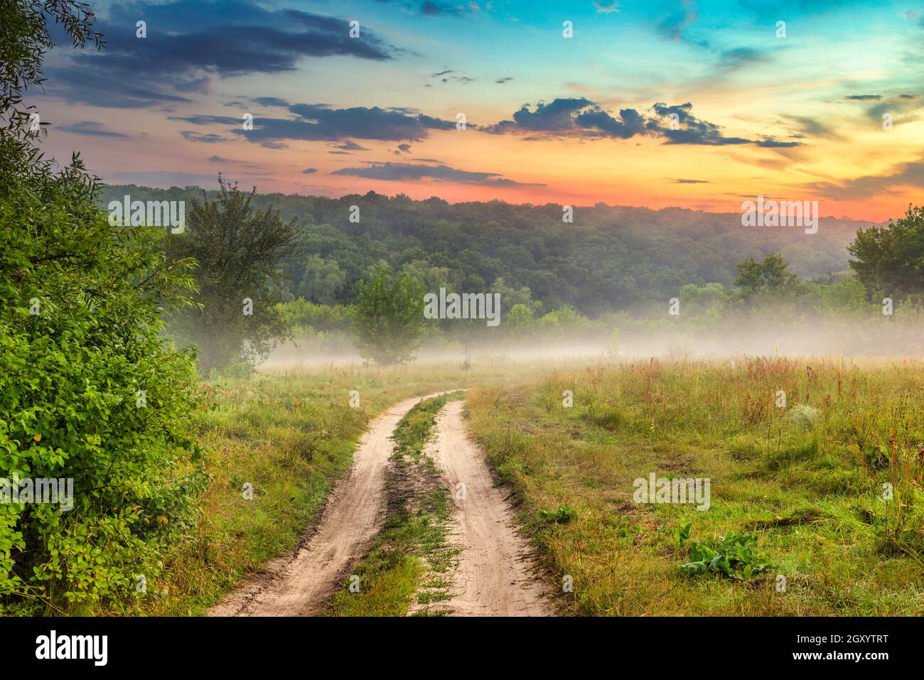 Sunrise over misty country road hi-res stock photography and images - Alamy