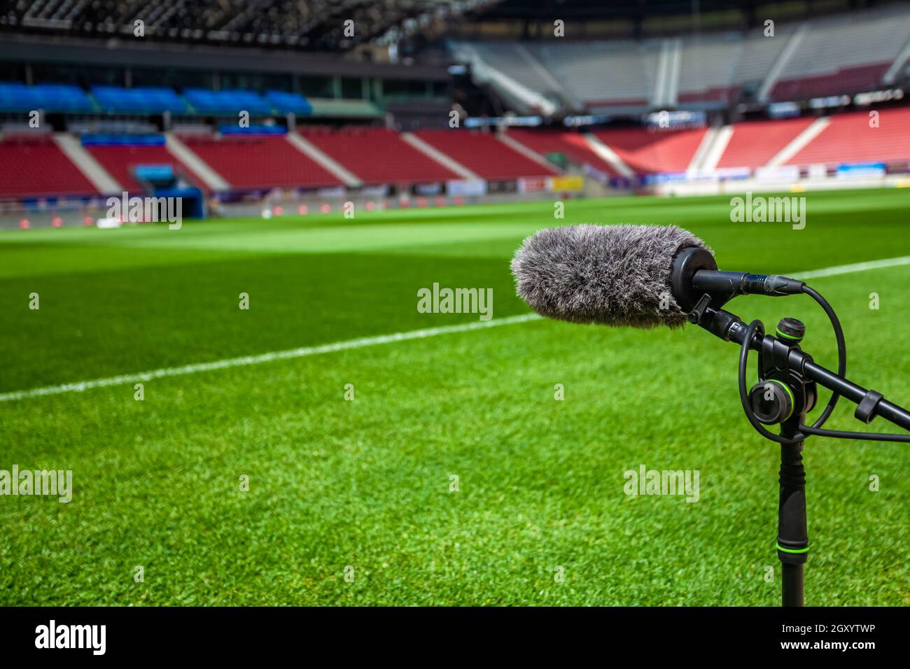 directional microphone on a football field to record the sound of a ...