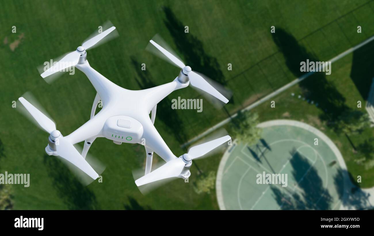 Unmanned Aircraft System (UAV) Quadcopter Drone In The Air Over A Park ...