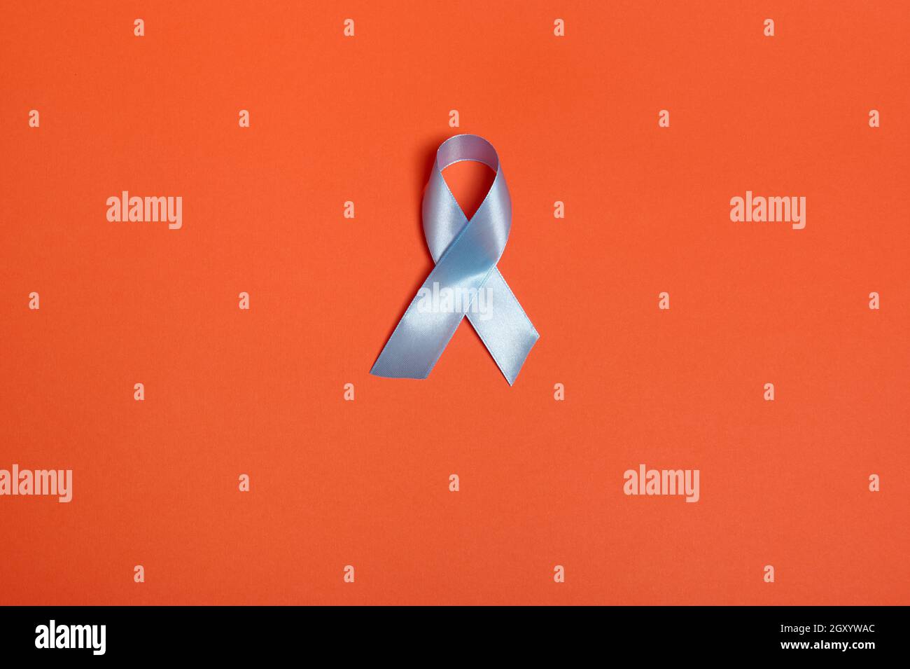 Flat lay of a blue satin ribbon, symbolic bow color raising awareness ...