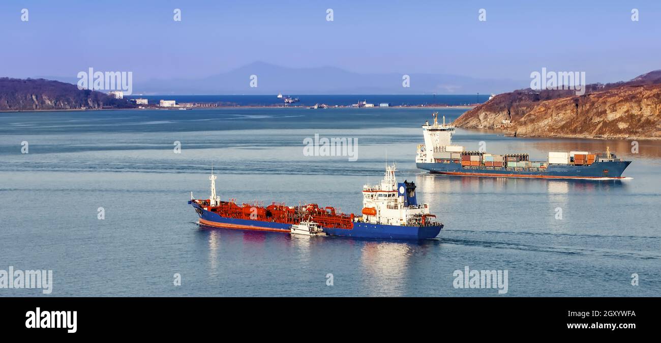 The Large container ship and reefer ship at blue sea. Selective focus ...