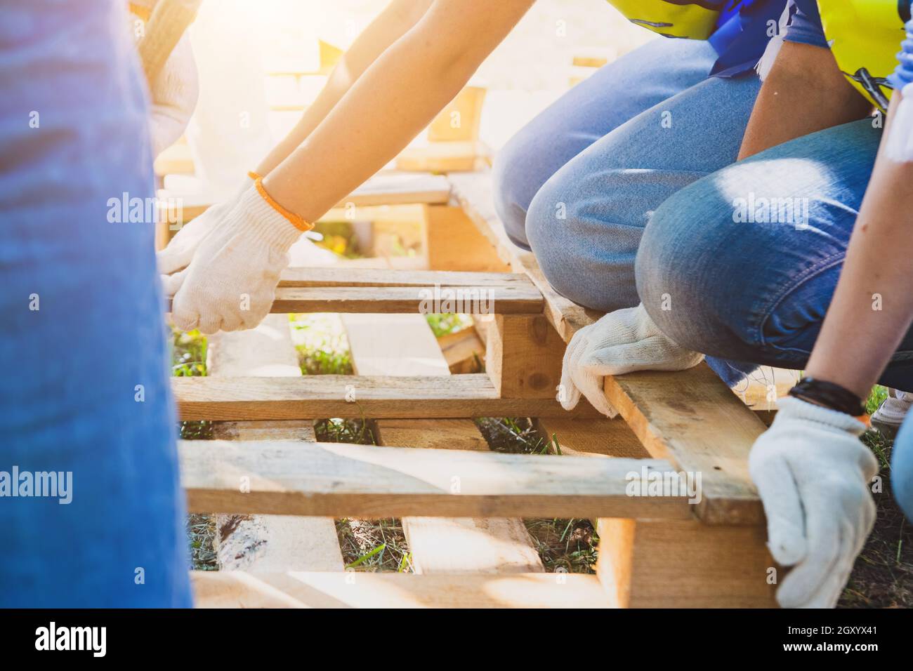 Working with wooden pallets. A man breaks a board in a pallet Stock ...