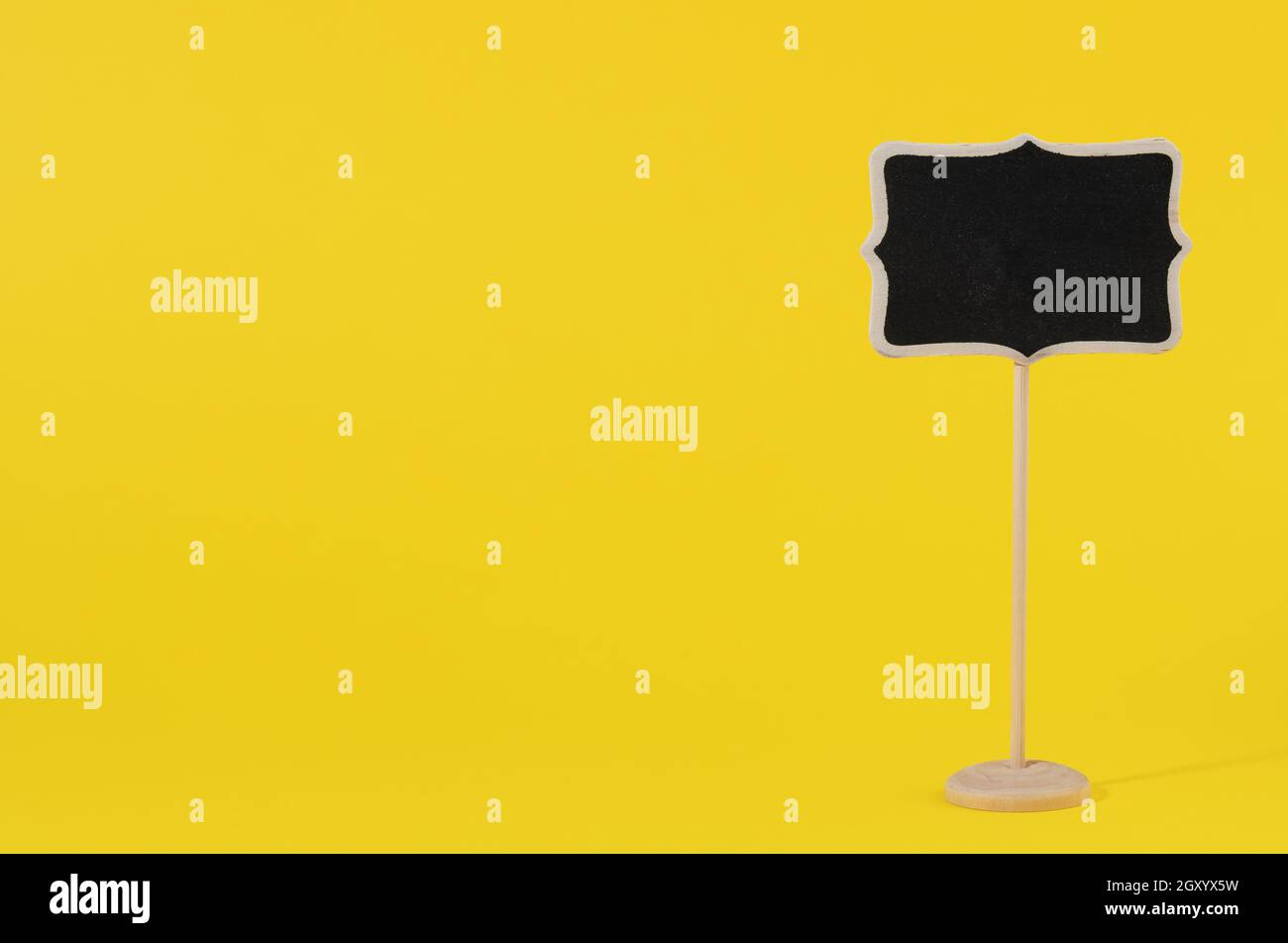 wooden pointer on a stick for writing text, yellow background, copy ...
