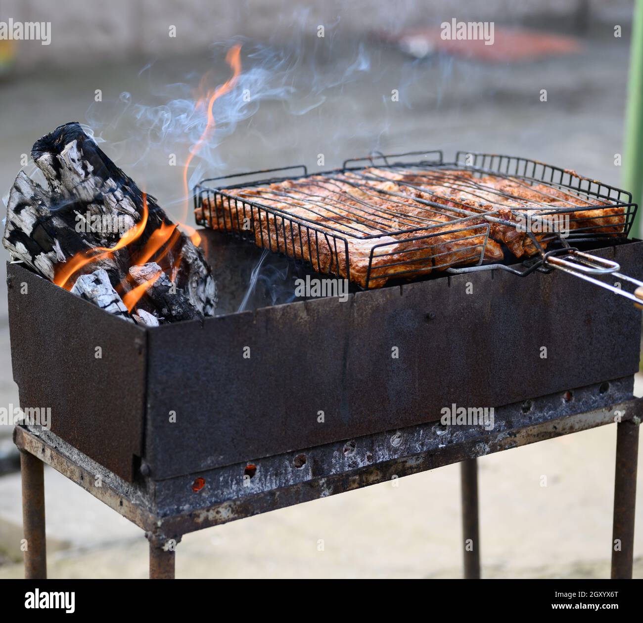 metal brazier with burning wood and meat on the grill, barbecue Stock ...