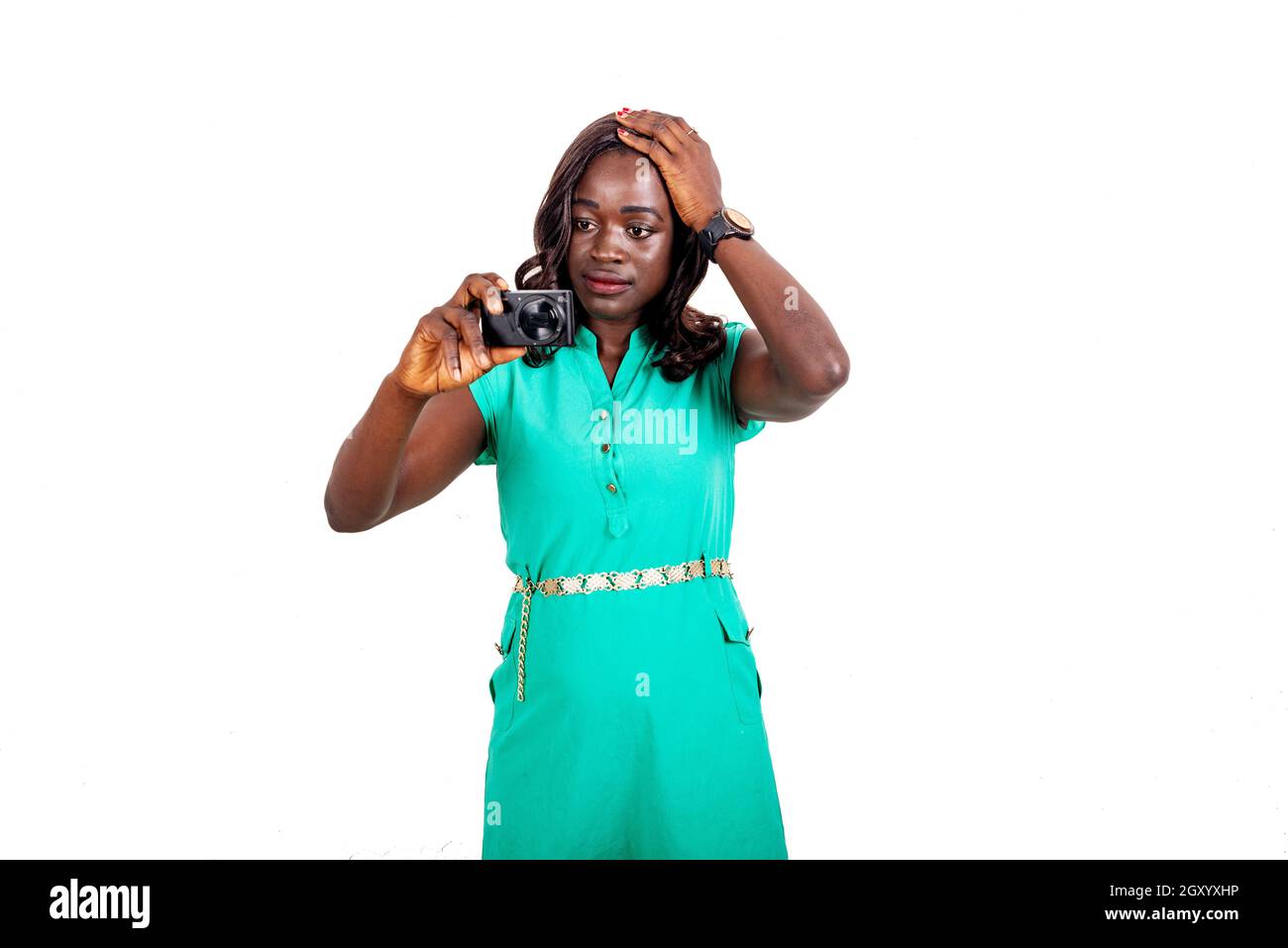 beautiful embarrassed young woman wearing a green dress holding and ...