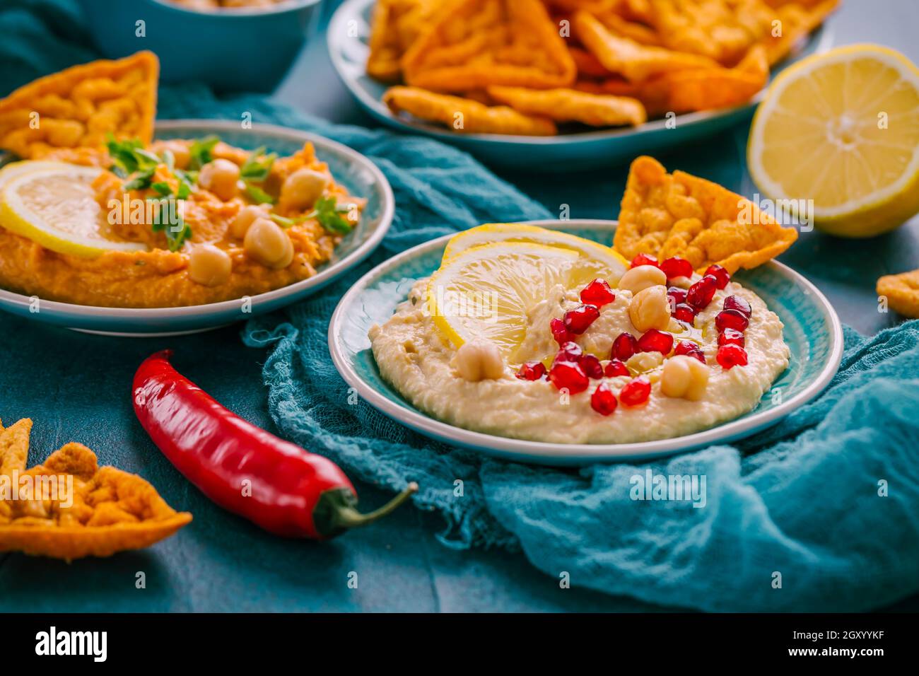 Homemade spicy humus with pomegranate seeds, chilli and chickpeas ...