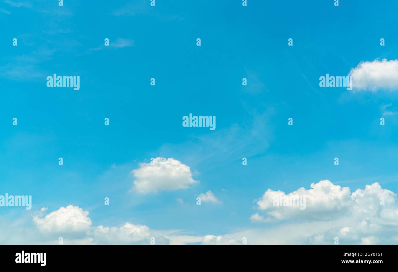 White fluffy cumulus clouds on blue sky with copy space for text. White ...