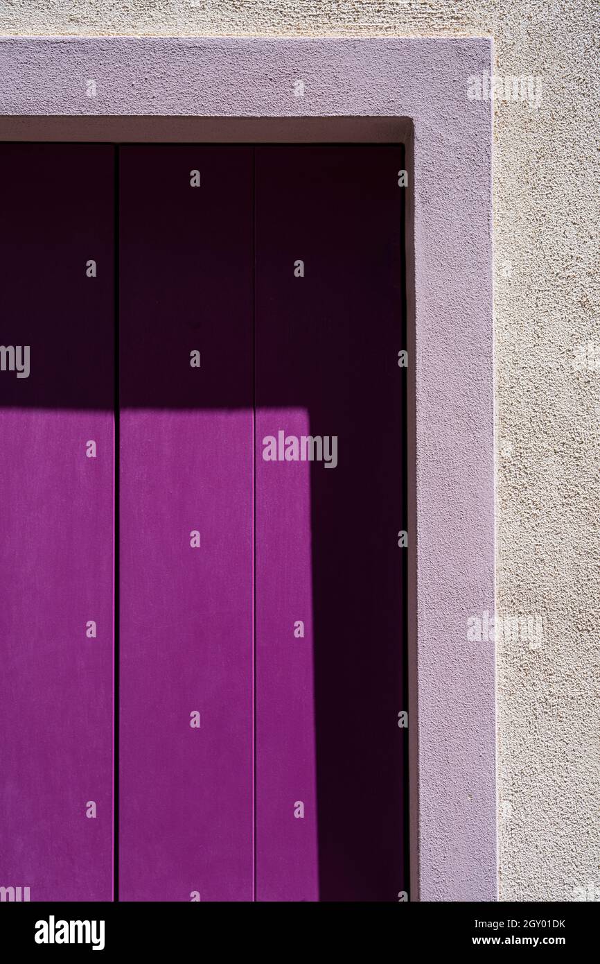a wooden violet window on a house in the town center of Caorle, Italy ...