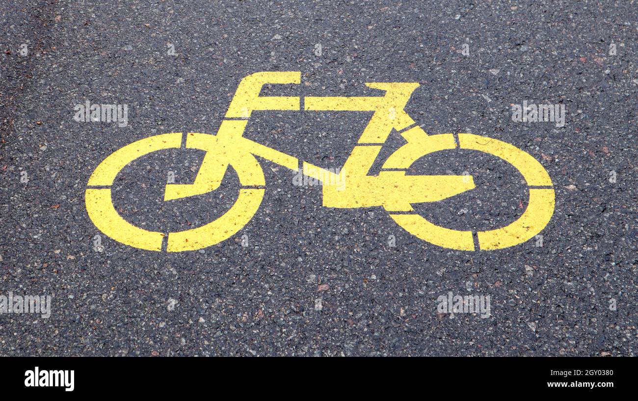 Bicycle symbol representing a path for bicycles. Yellow painted sign ...