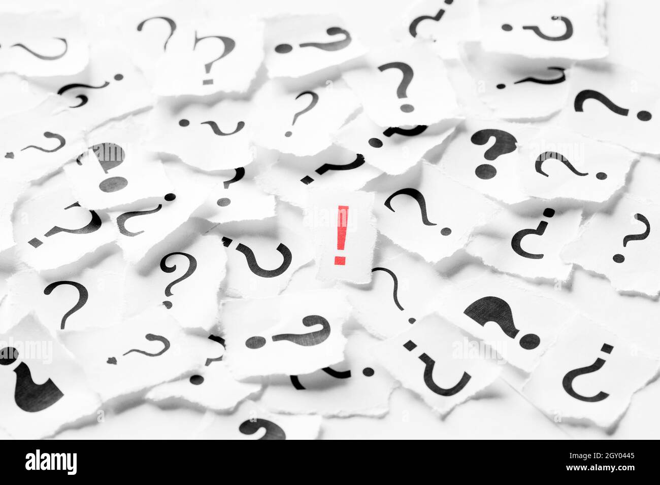 Pile of question mark signs scattered around with one red exclamation ...