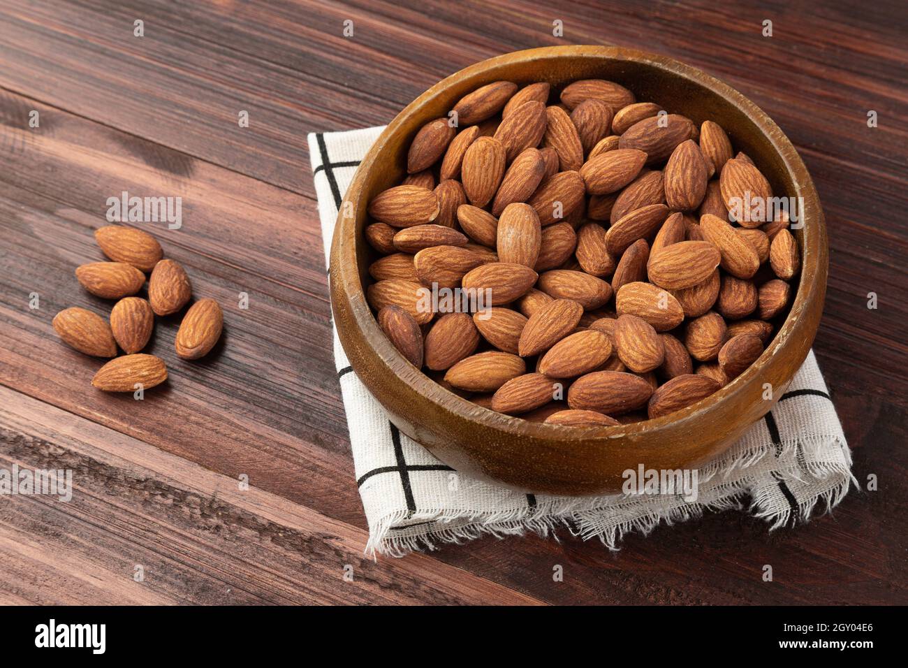 Almonds in wooden bowl on the table, Healthy snack, Vegetarian food ...