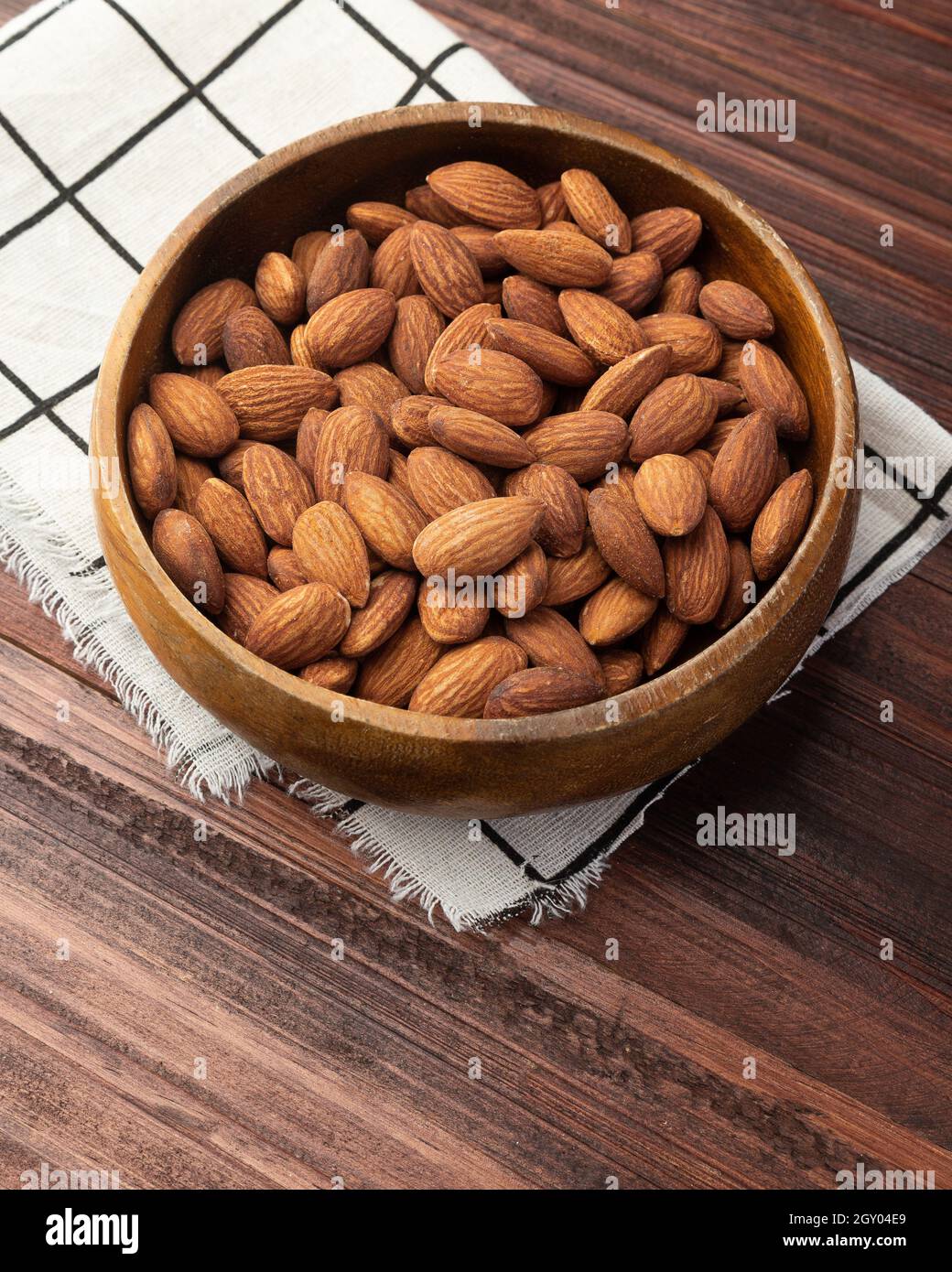 Almonds in wooden bowl on the table, Healthy snack, Vegetarian food ...