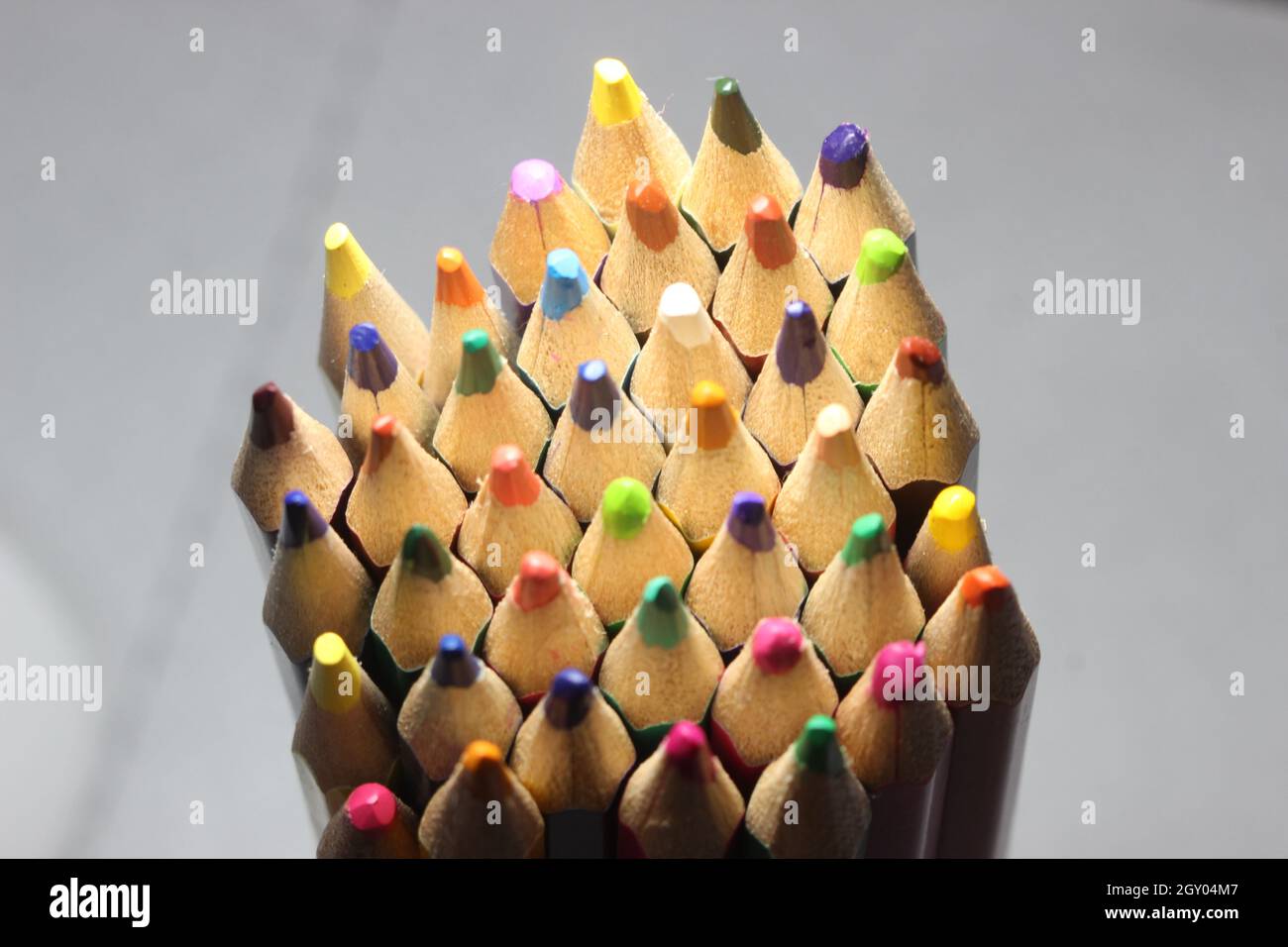 Close-up view of bright colored multicolor pencils on black background ...