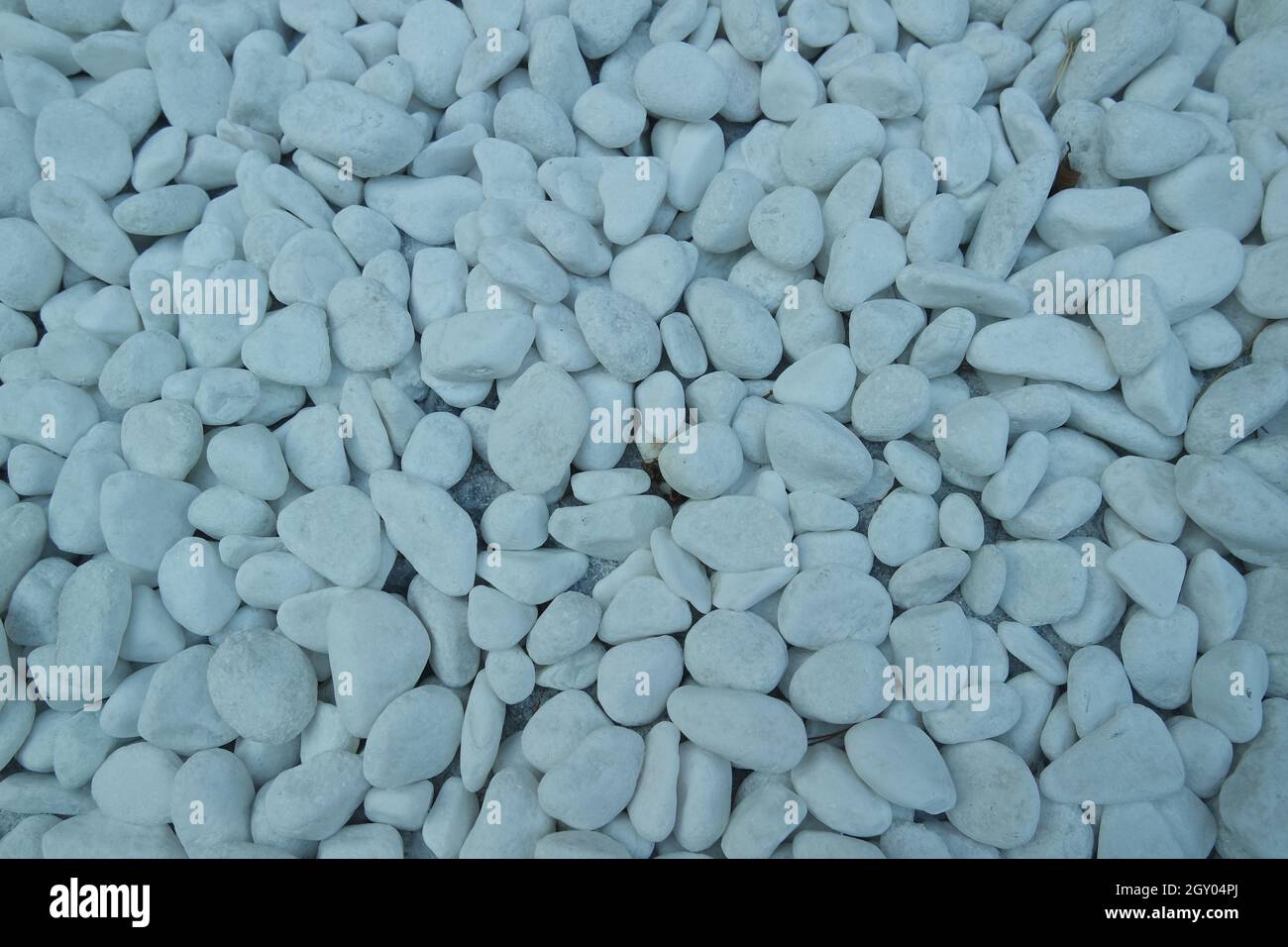 Top view of white stones background Stock Photo - Alamy