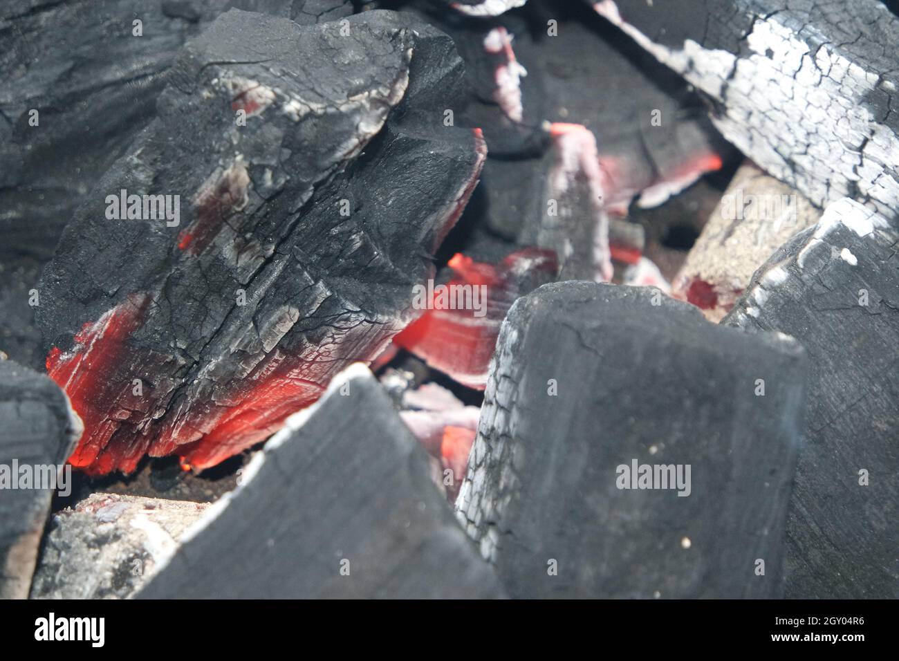 Fire on logs in fire pot with embers and burning coal. Bonfire with ...