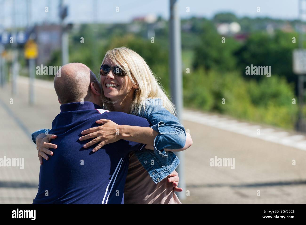 couple hugging on a train platform, greeting , Germany Stock Photo - Alamy