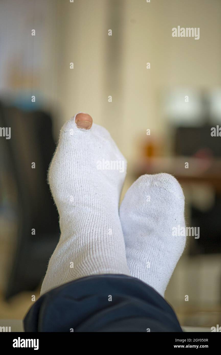 big toe peeping out of a hole in the sock Stock Photo - Alamy