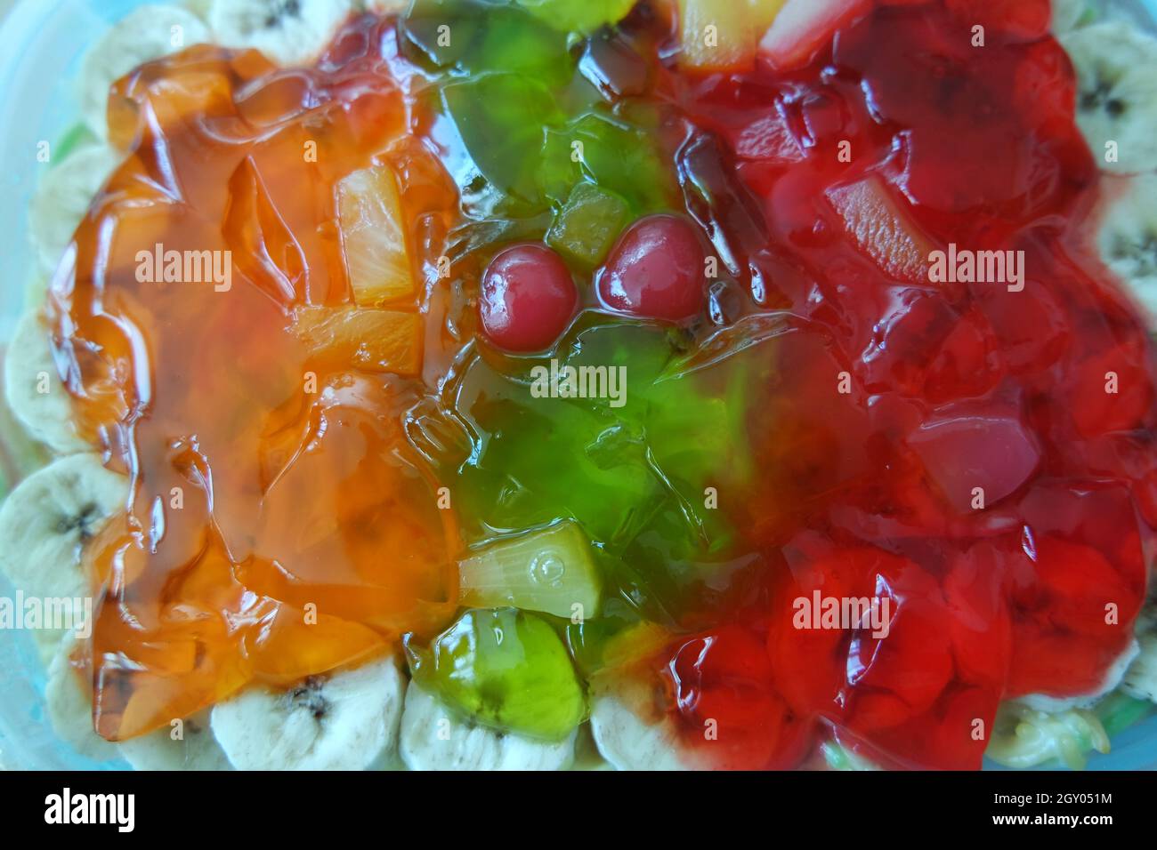 Creamy custard sweet dish with with different slices layered on surface ...