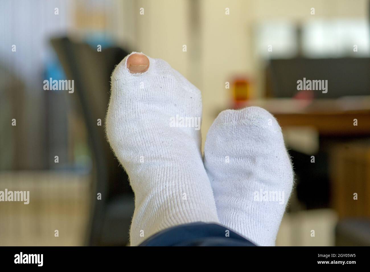 big toe peeping out of a hole in the sock Stock Photo - Alamy