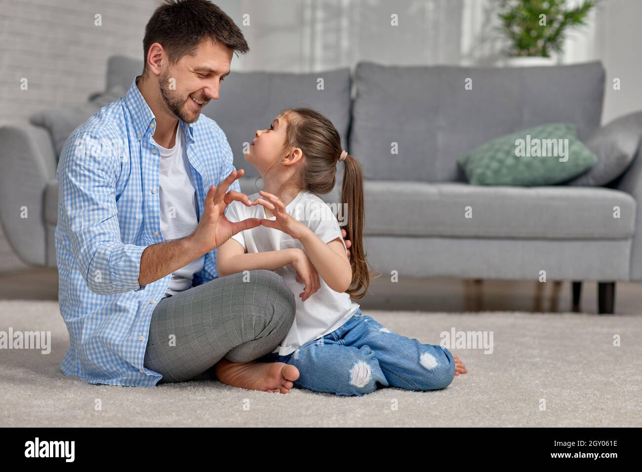handsome father and cute little child daughter showing love sign. dad ...