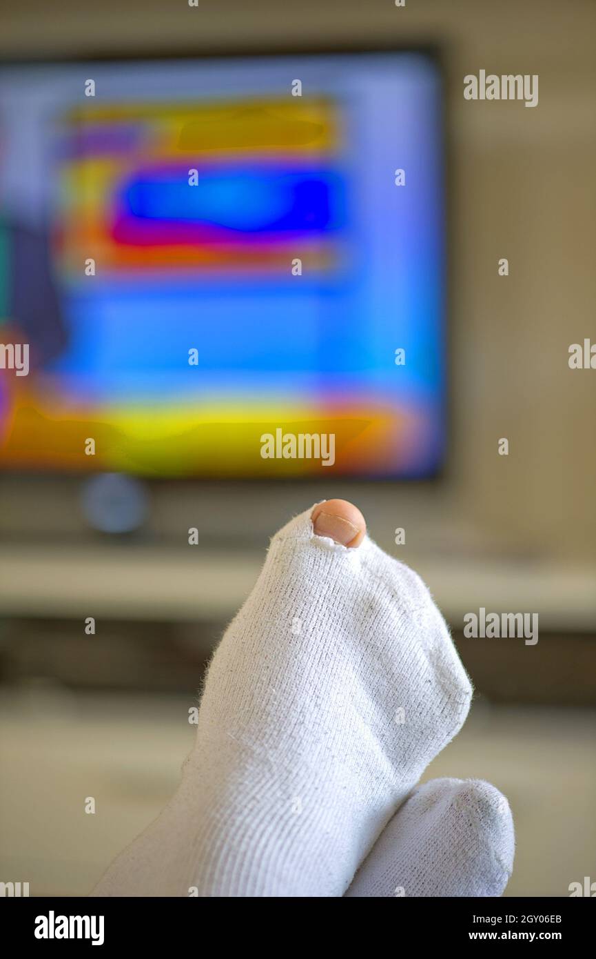 big toe peeping out of a hole in the sock Stock Photo - Alamy